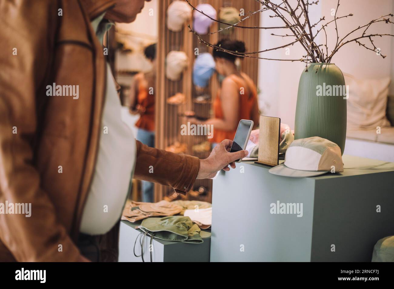 Midsection of senior man scanning QR code through smart phone at ...
