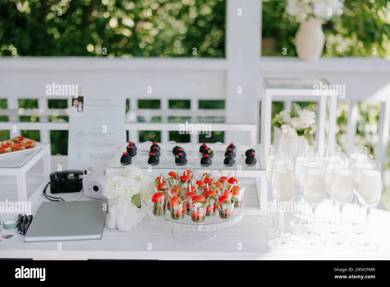 Wedding banquet table setting with wineglasses, snacks and canapes ...