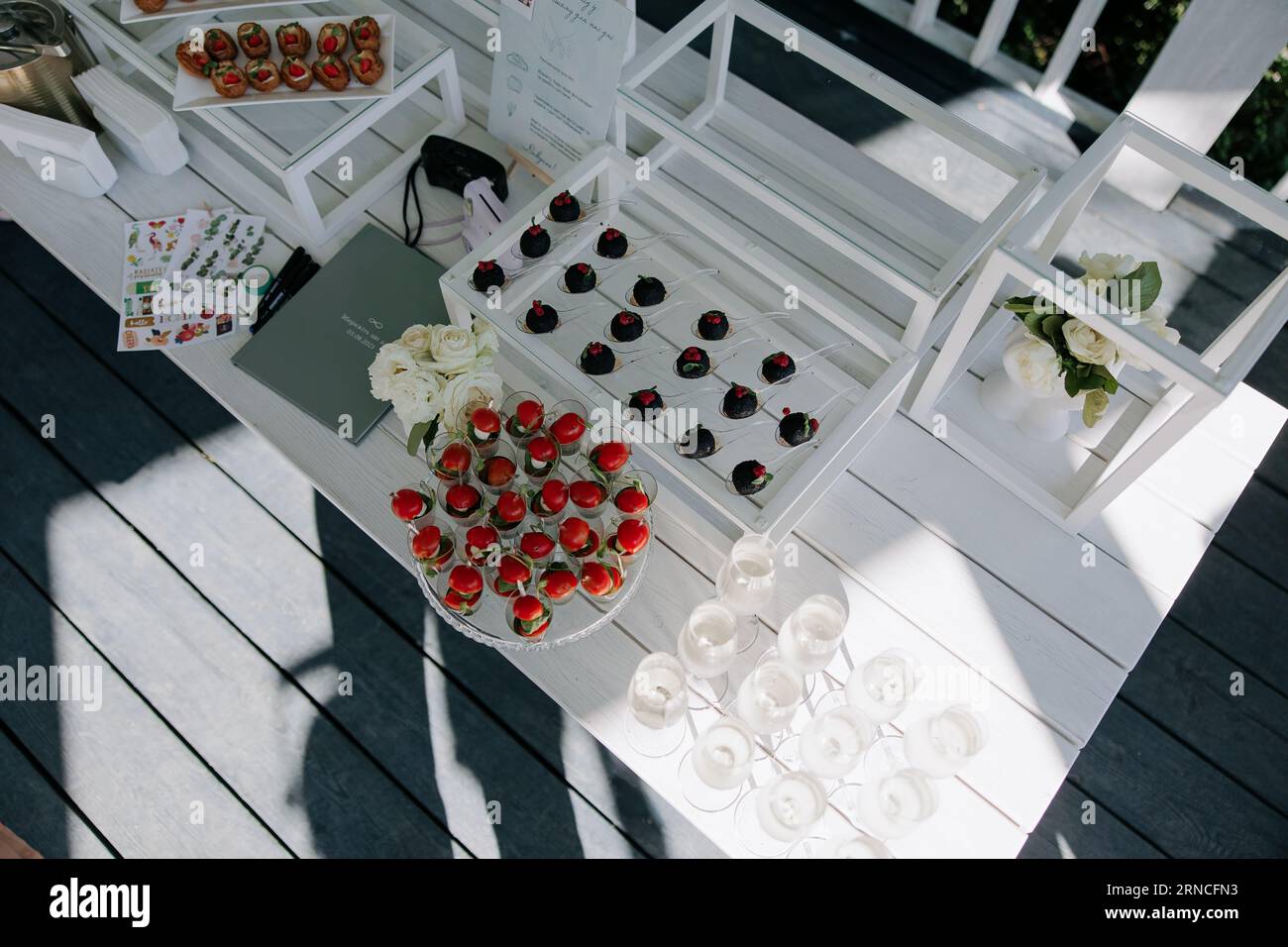 Wedding banquet table setting with wineglasses, snacks and canapes ...