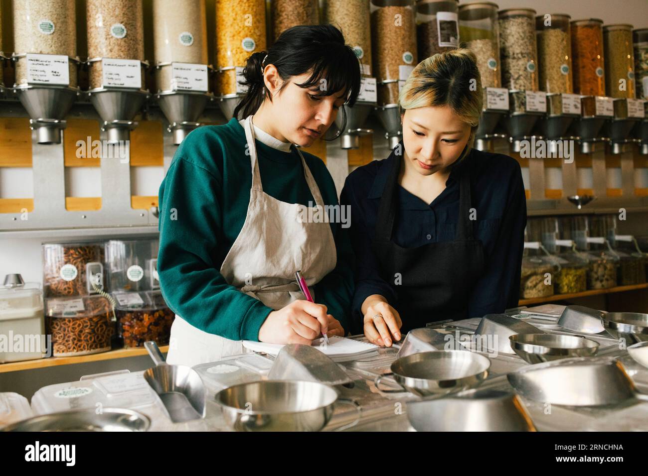 Multiracial female colleagues taking inventory in food store Stock ...