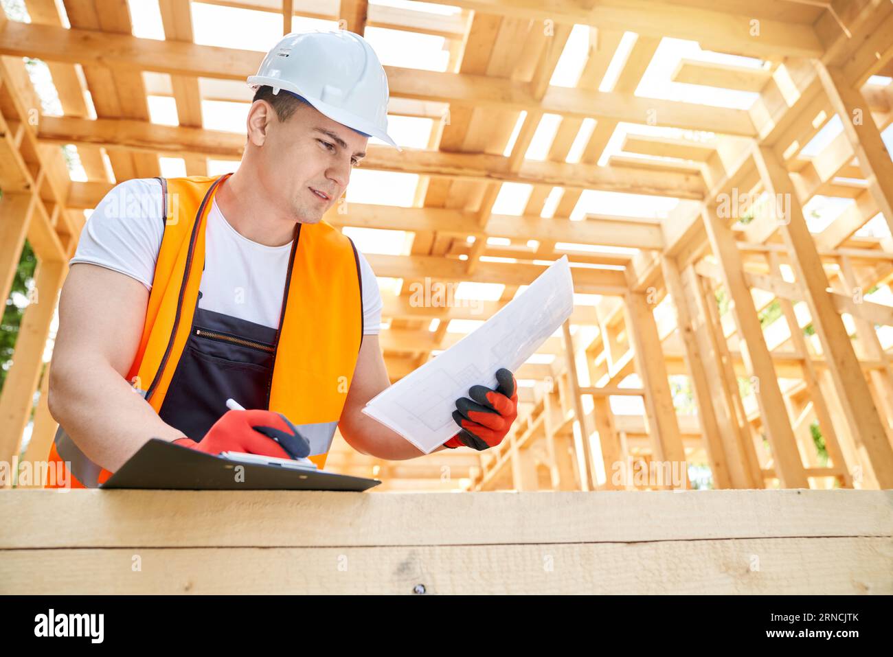 Male architect, engineer, builder standing, constructing building ...