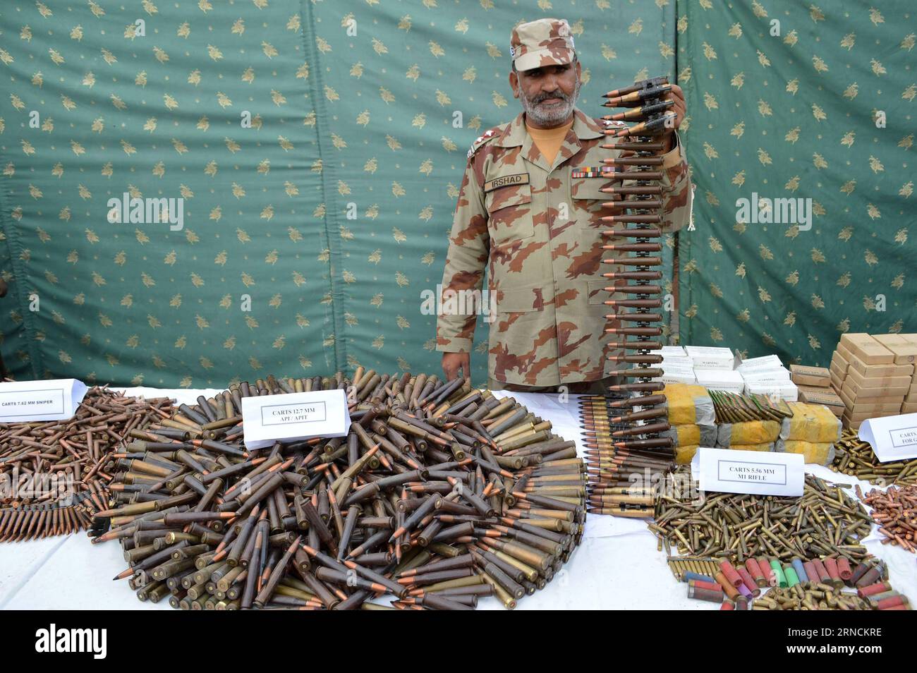 A Pakistani security personnel display seized bullets in southwest ...