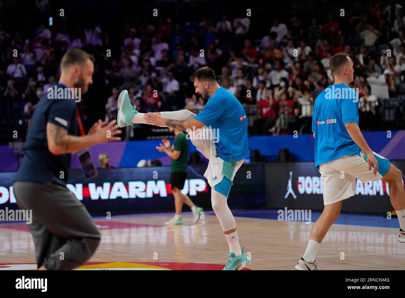 Slovenia guard Luka Doncic (77), center, and his team members do warm ...