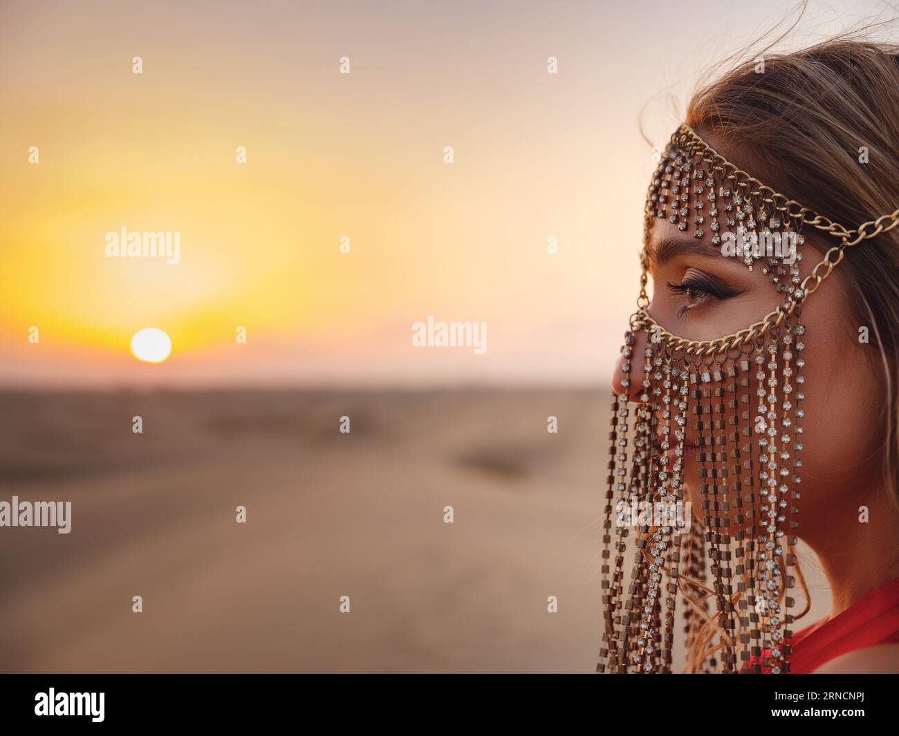 Young arabian Woman in red silk dress with gold veil accessories hide ...