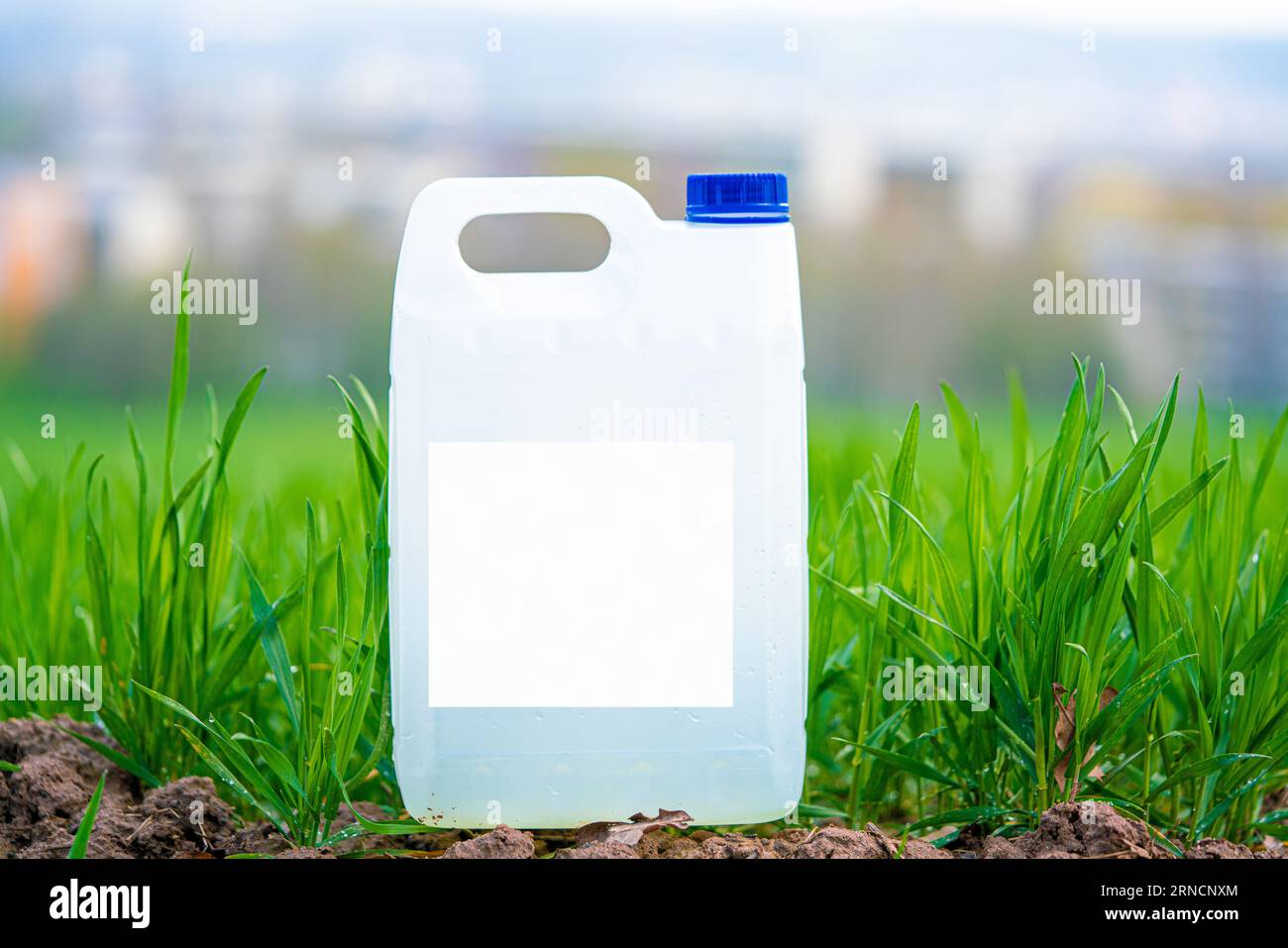white plastic container with agricultural chemicals or fertilizers on a ...