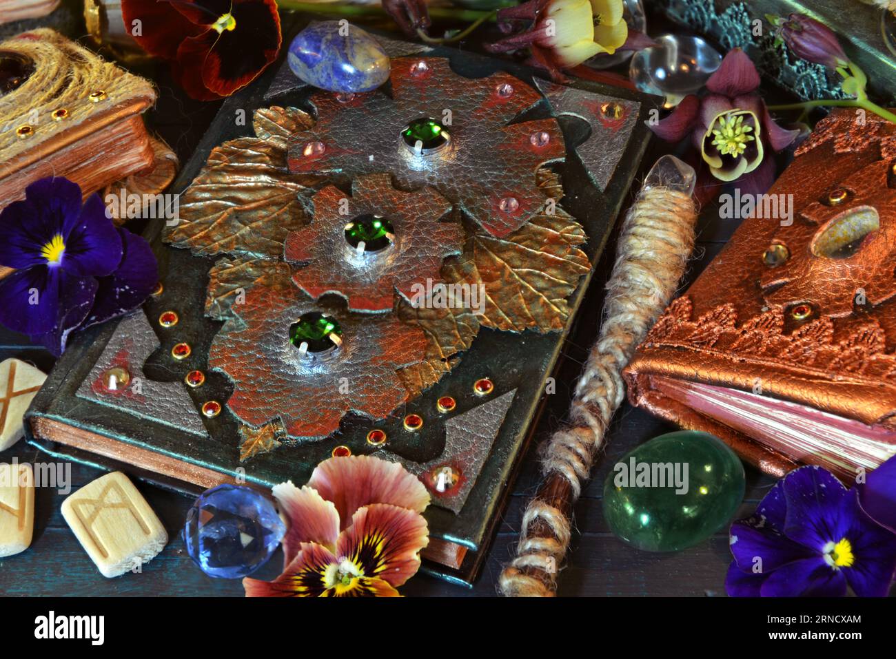 Still life with magic book of spells, runes and wand on witch table ...