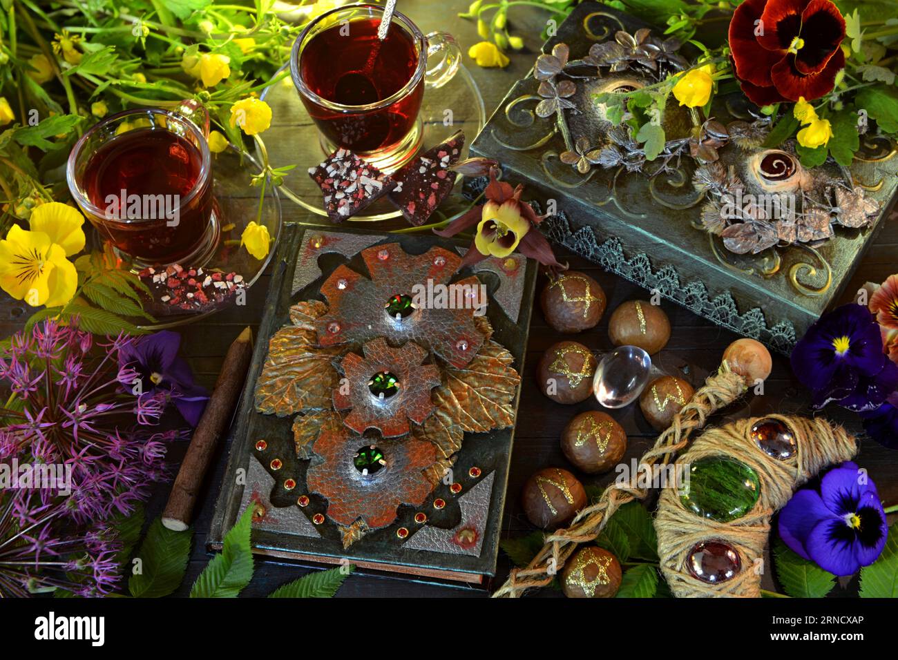 Still life with magic book of spells, runes and wand on witch table ...