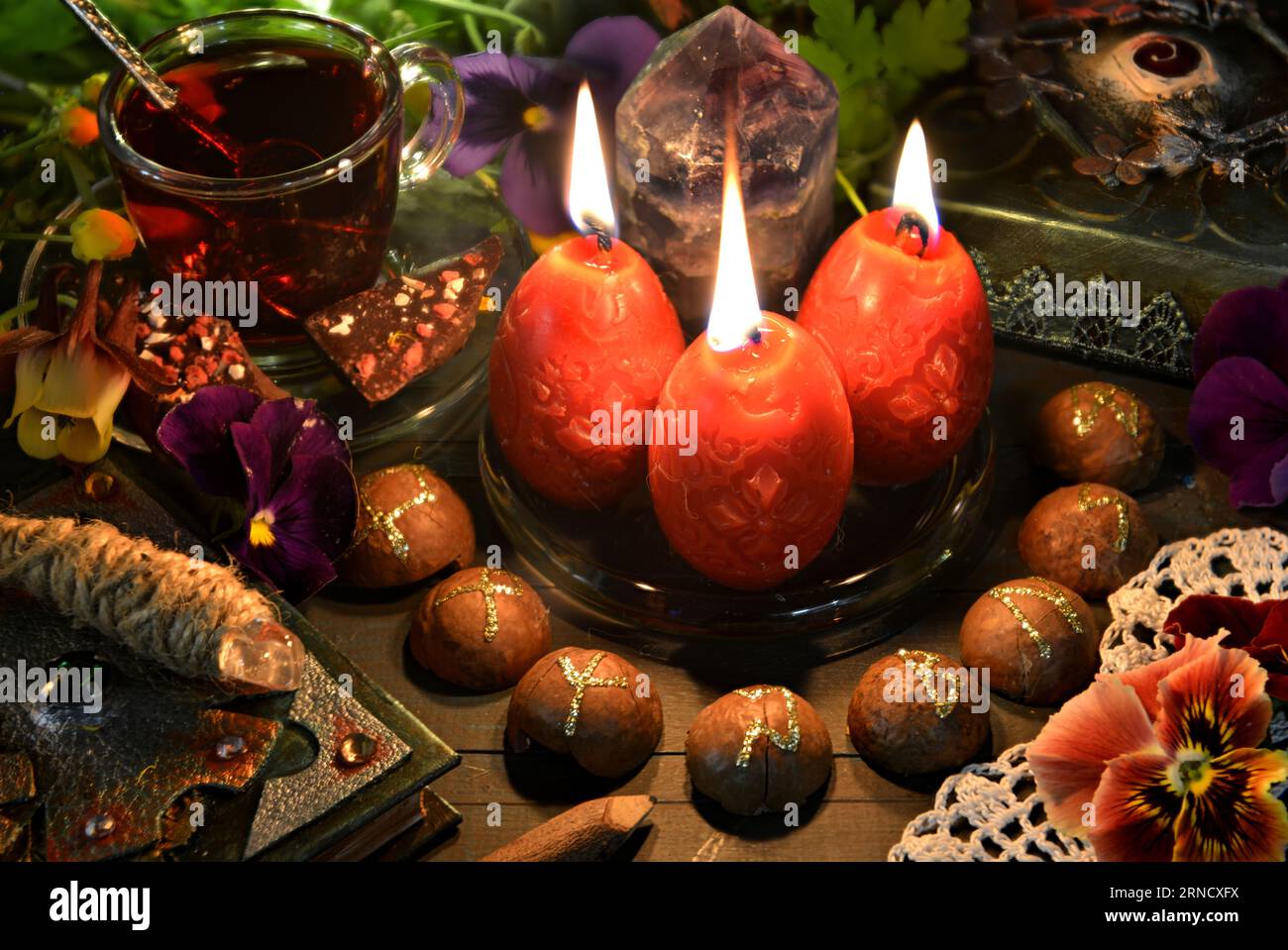 Still life with magic book of spells, runes and cup on witch ritual ...