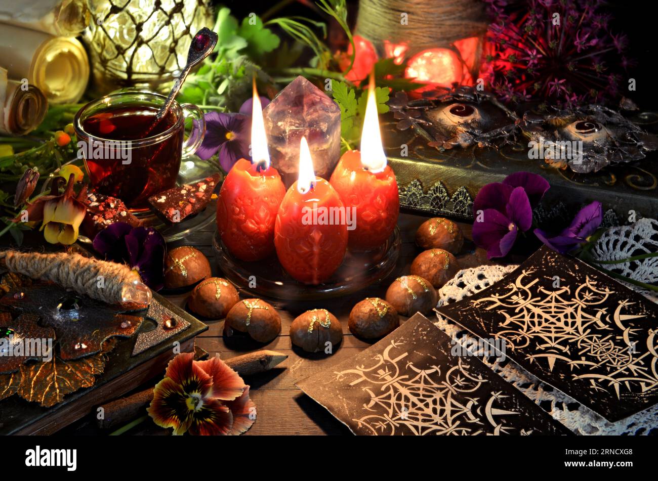 Still life with magic book of spells, runes and cup on witch ritual ...