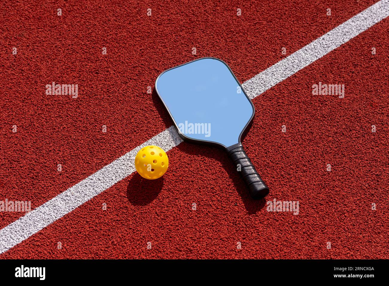 Pickleball racket and ball on orange background. Horizontal education ...