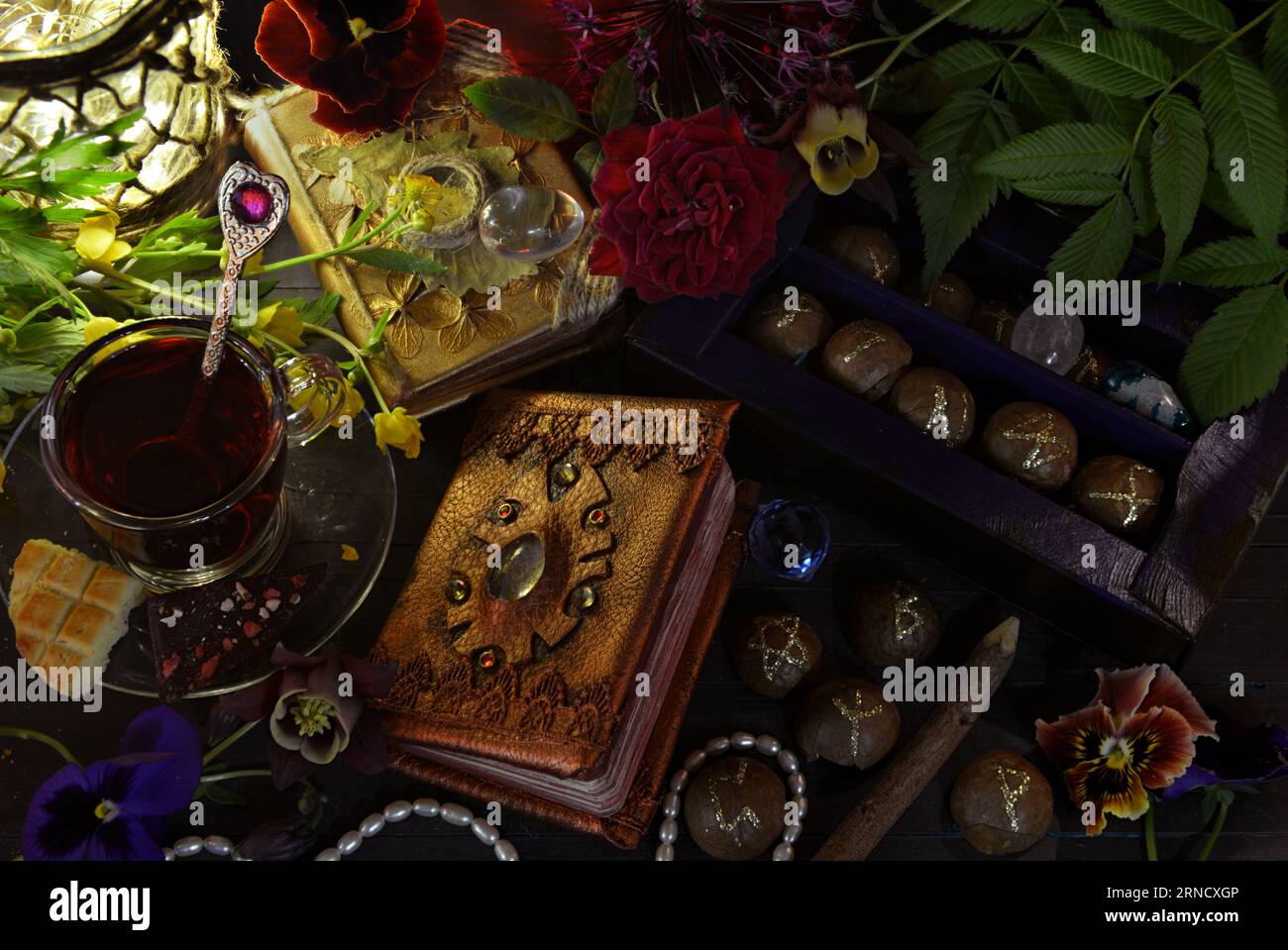 Still life with magic book of spells, runes and cup on witch ritual ...