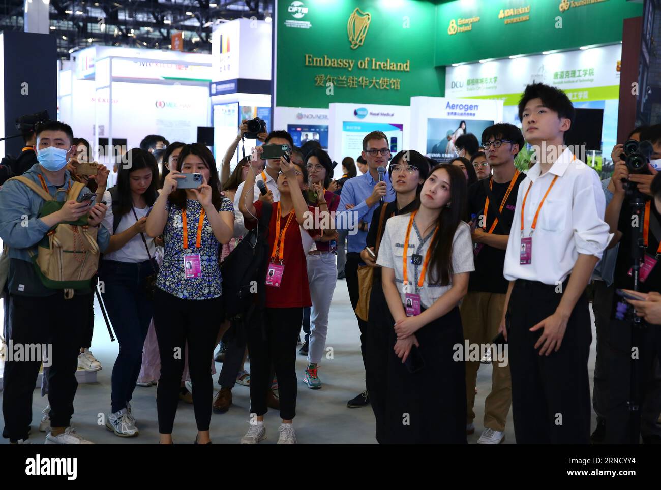 Beijing, China. 1st Sep, 2023. An exhibitor (C) introduces a booth to ...