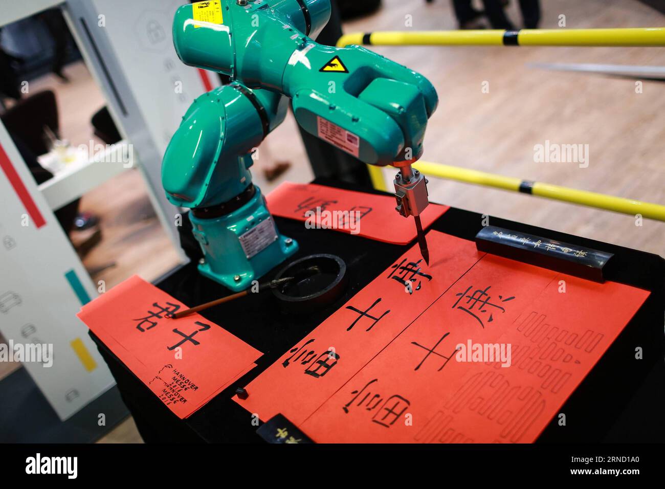 Hannover Messe HANOVER, April 27, 2016 -- A robot displays calligraphy ...