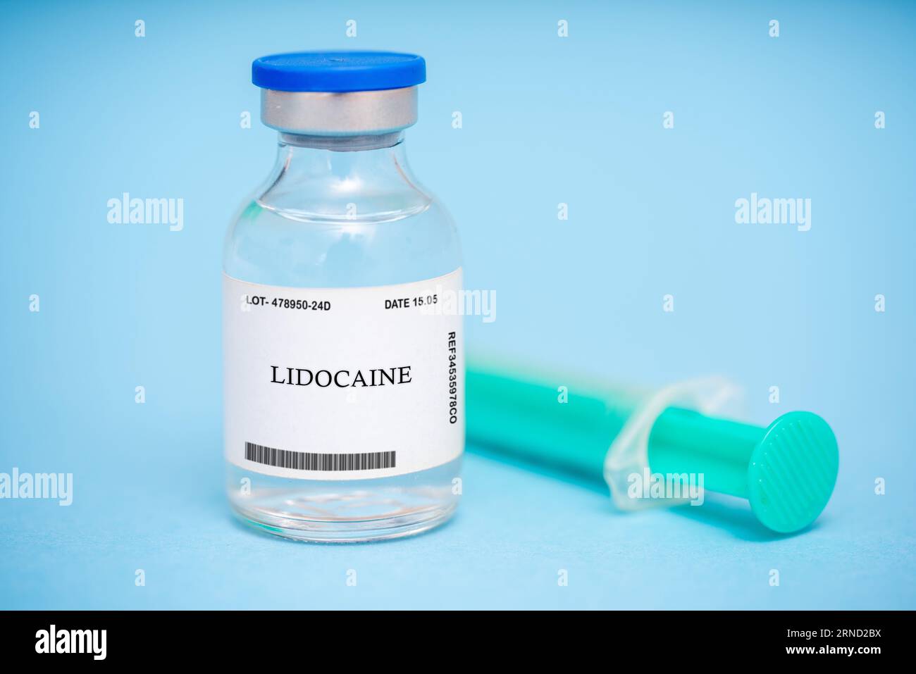 Glass vial of lidocaine injection solution for pain relief on white ...