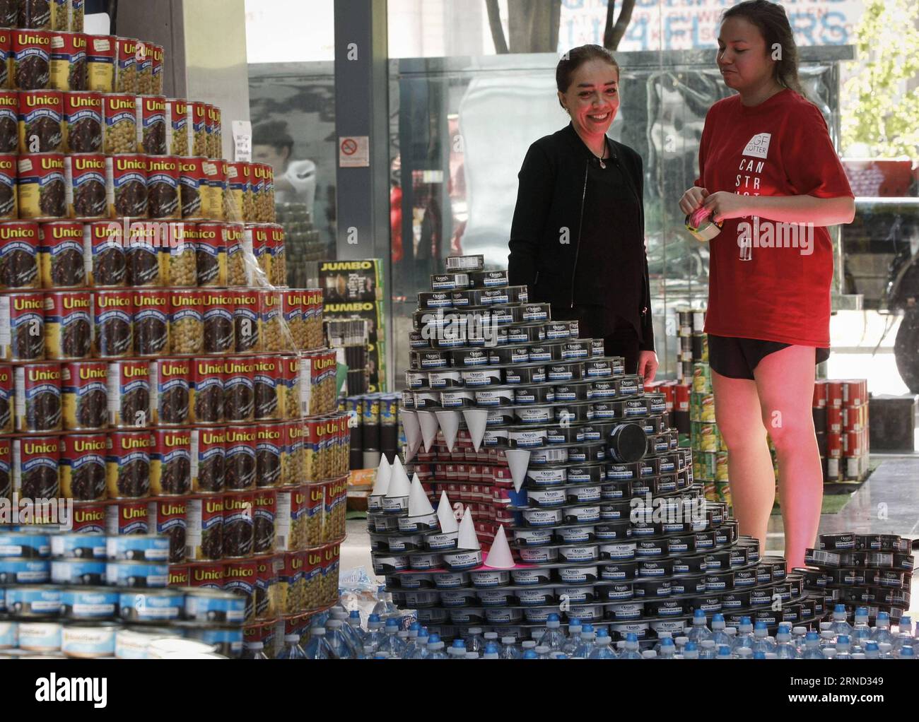 Residents look at the sculptures built by canned food at the annual ...
