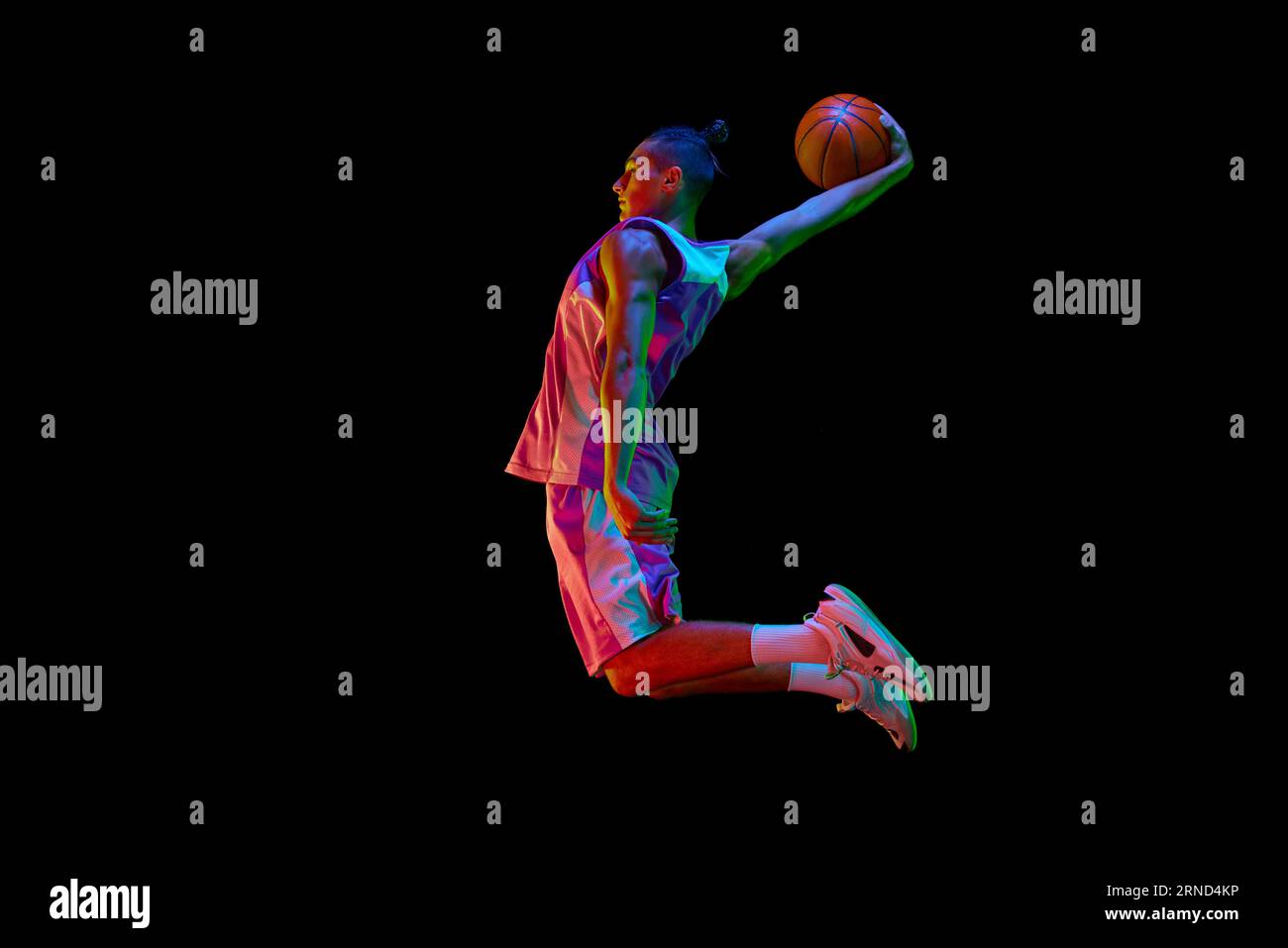 Athletic young guy, basketball player in motion during match, jumping ...