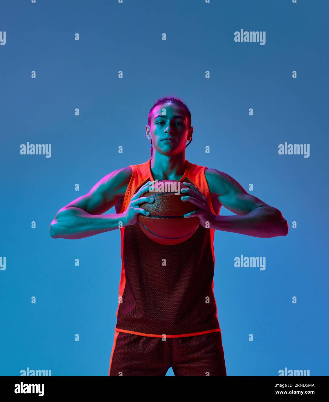 Basketball player, handsome teen boy in uniform standing with ball and ...