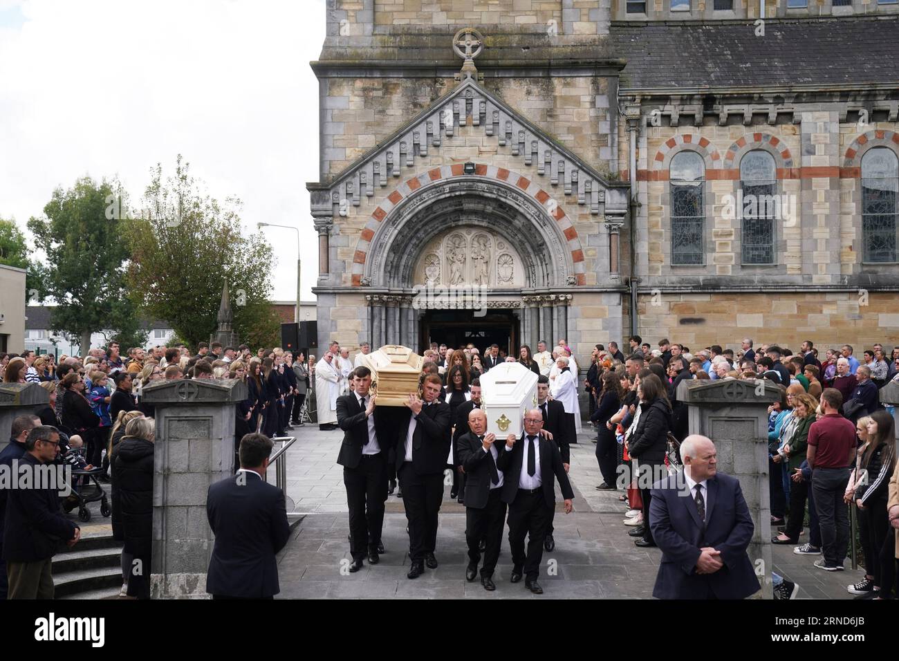 The coffins of siblings Luke, 24 and Grace McSweeney, 18, are carried ...
