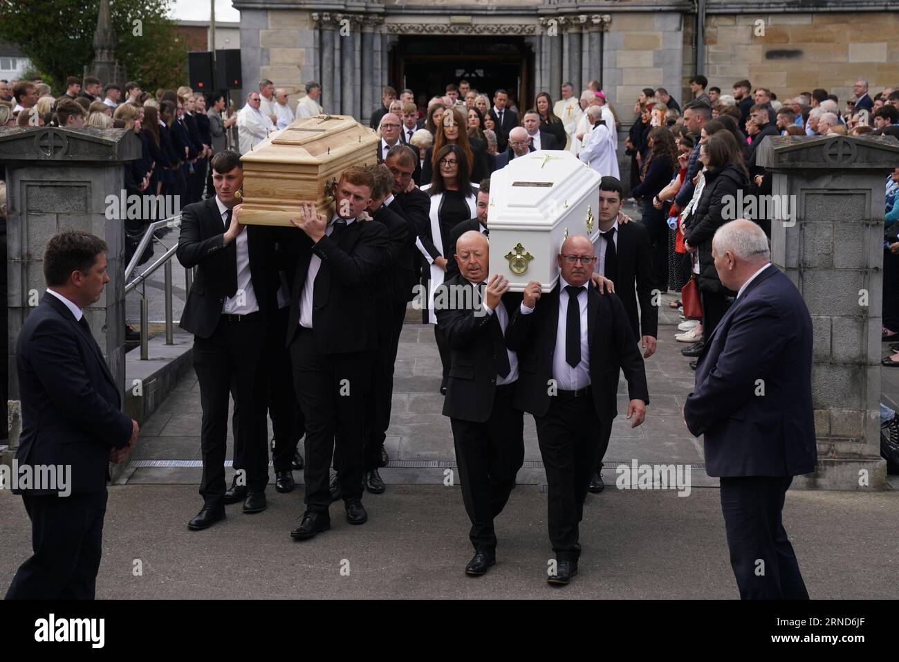 The coffins of siblings Luke, 24 and Grace McSweeney, 18, are carried ...