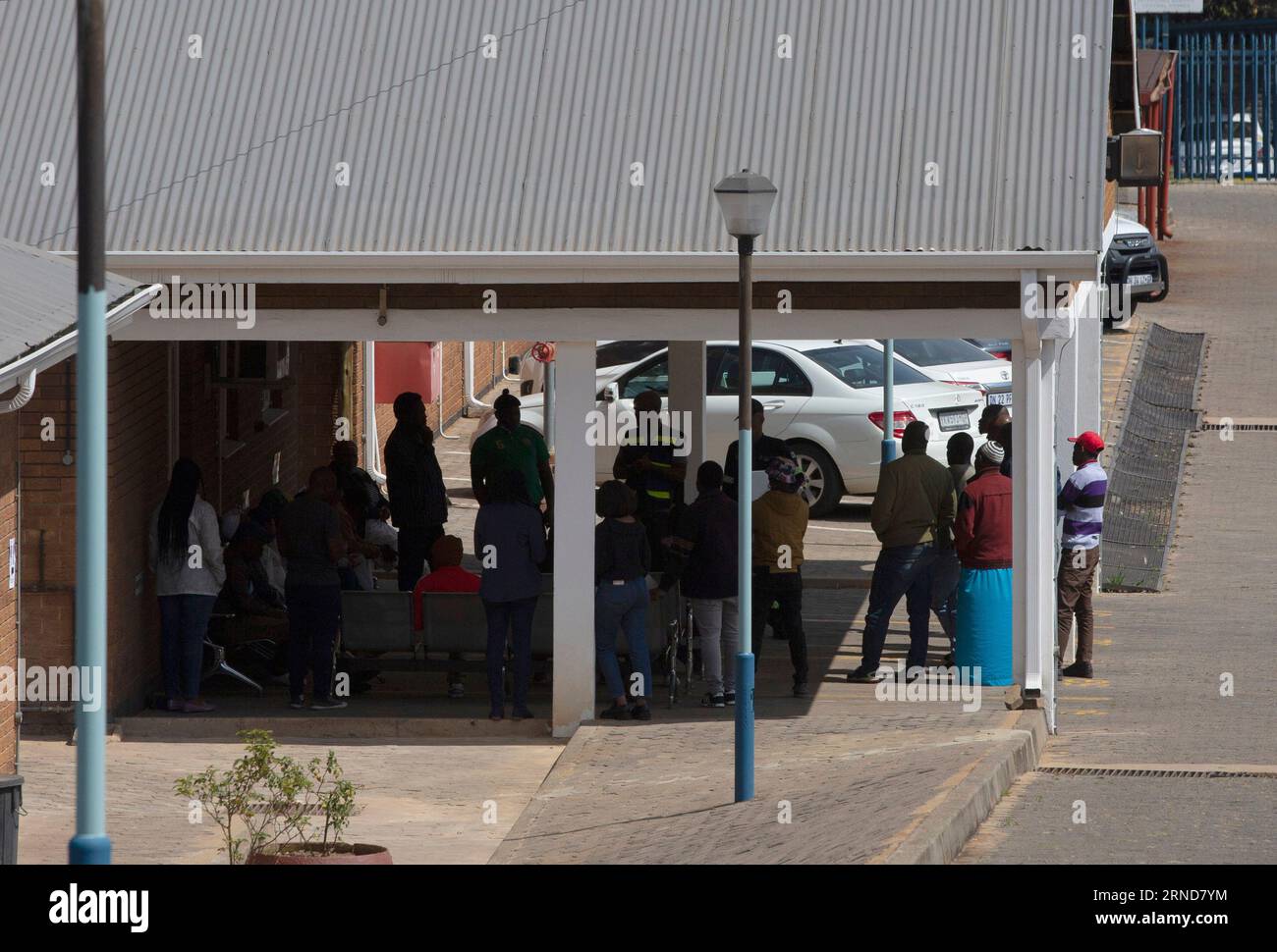 People queue at a forensic mortuary to identify bodies in Soweto ...