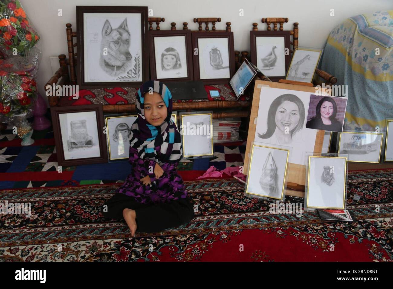 KABUL, May 03, 2016 -- Rababa poses in front of her paintings at her ...