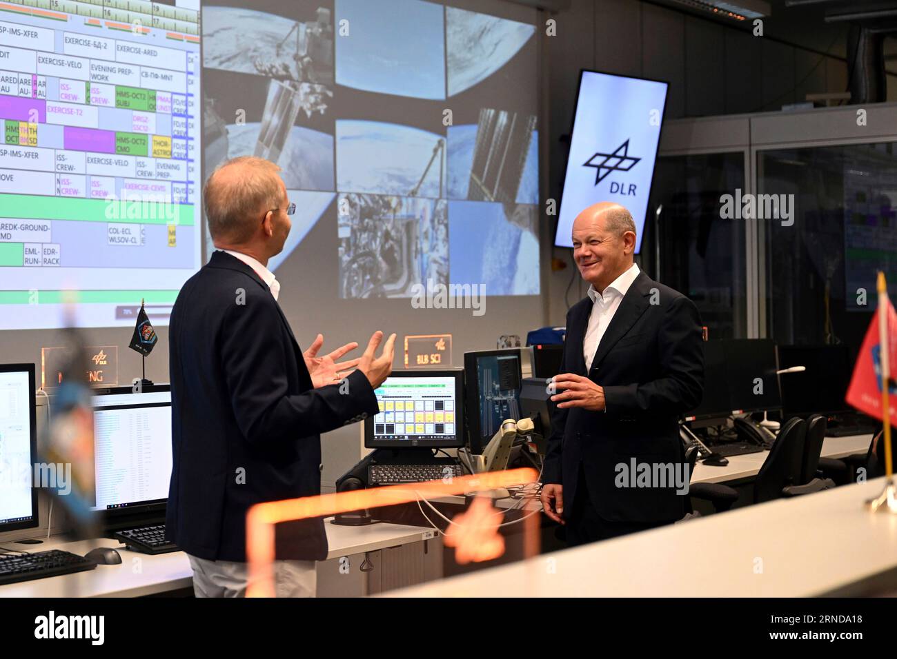 German Chancellor Olaf Scholz, right, speaks with Felix Huber, director ...