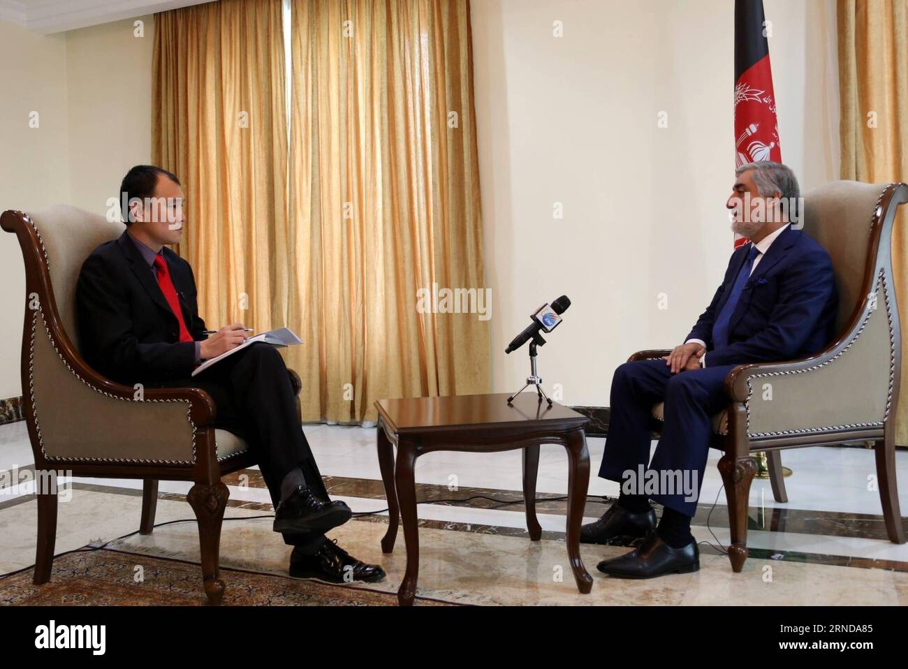 Afghan Chief Executive Abdullah Abdullah (R) receives an interview with ...