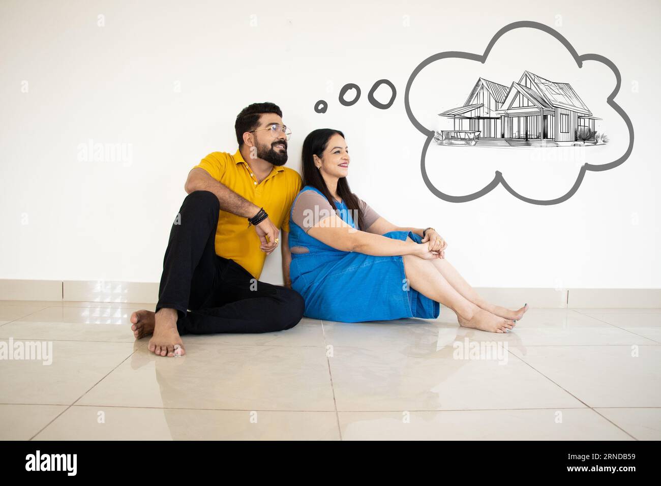 Young Indian Couple Sitting On Floor Thinking Of Getting Their Own ...