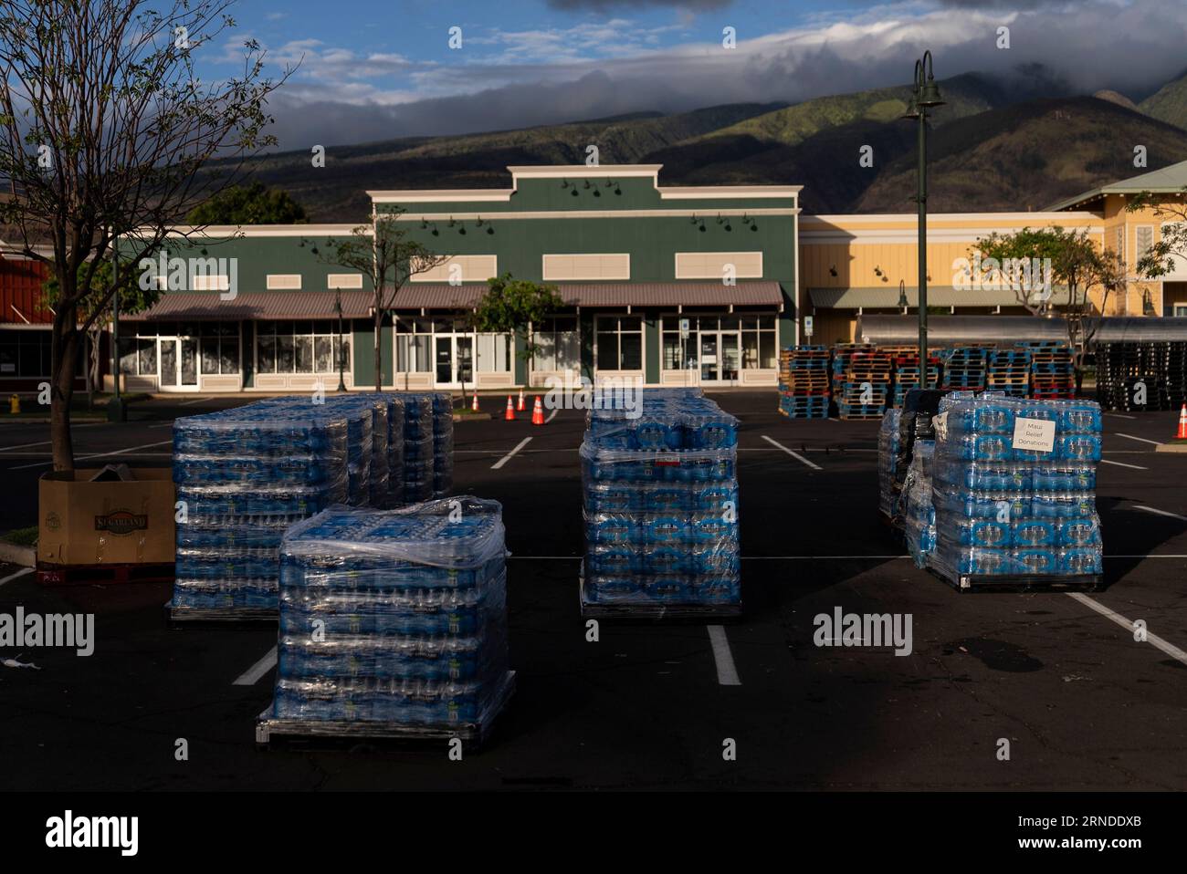 Bottled water is stacked at a food and supply distribution center in ...