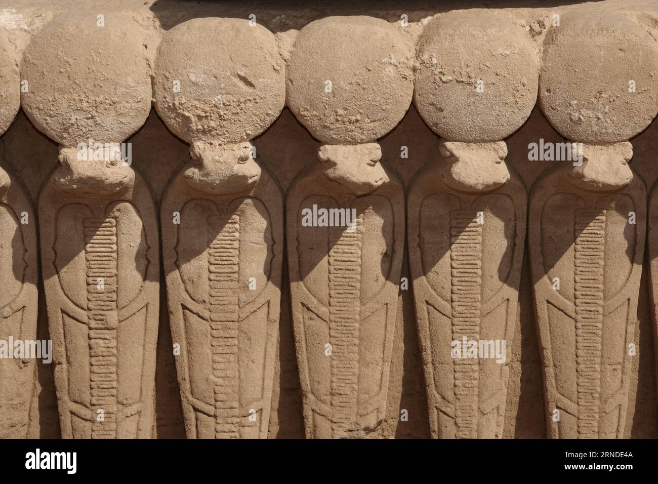 remnants of Cobra frieze block at the Temple of Hathor at Dendera, Nile ...