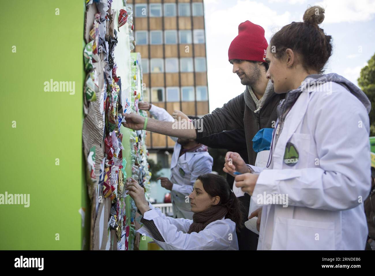 People make a three-dimensional mural with recyclable materials to ...