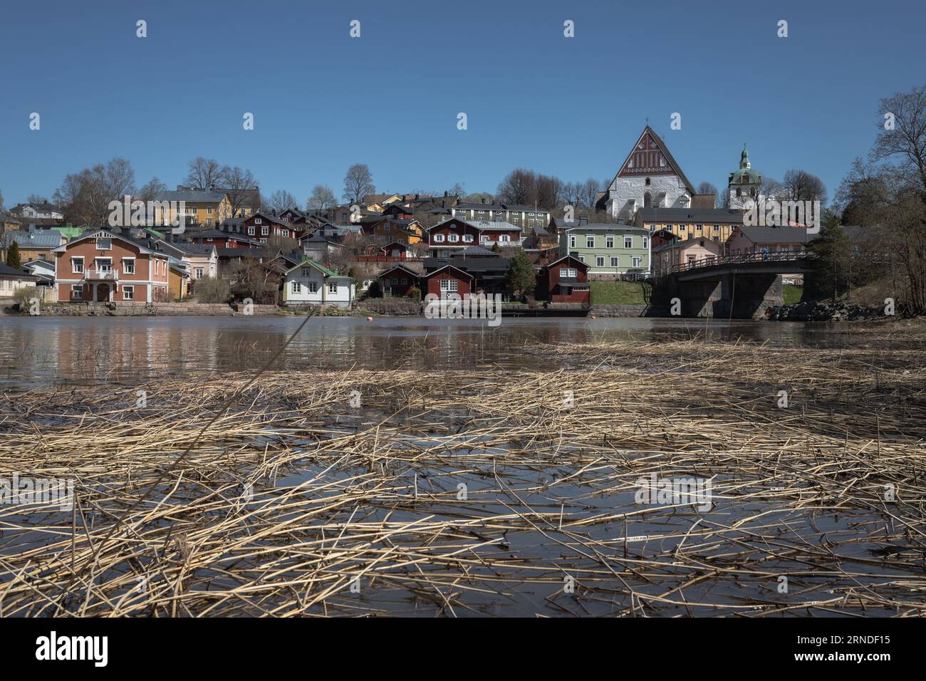 A view of a small rural village with a landscape featuring a small body ...