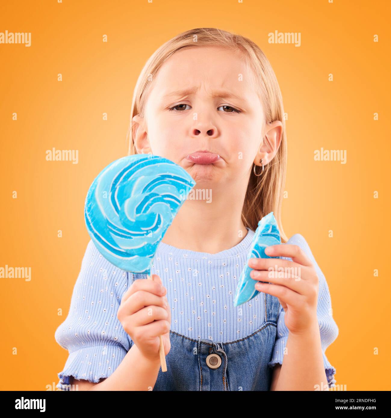 Portrait, children and sad girl with a broken lollipop on an orange ...