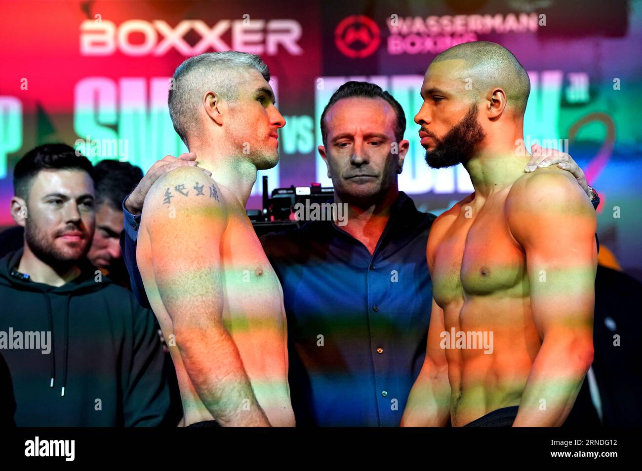Boxing promoter Kalle Sauerland (centre) steps in between Liam Smith ...