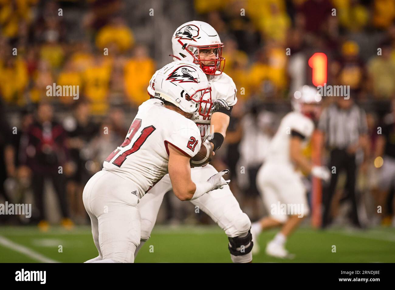 Southern Utah quarterback Justin Miller (12) hands off to running back ...