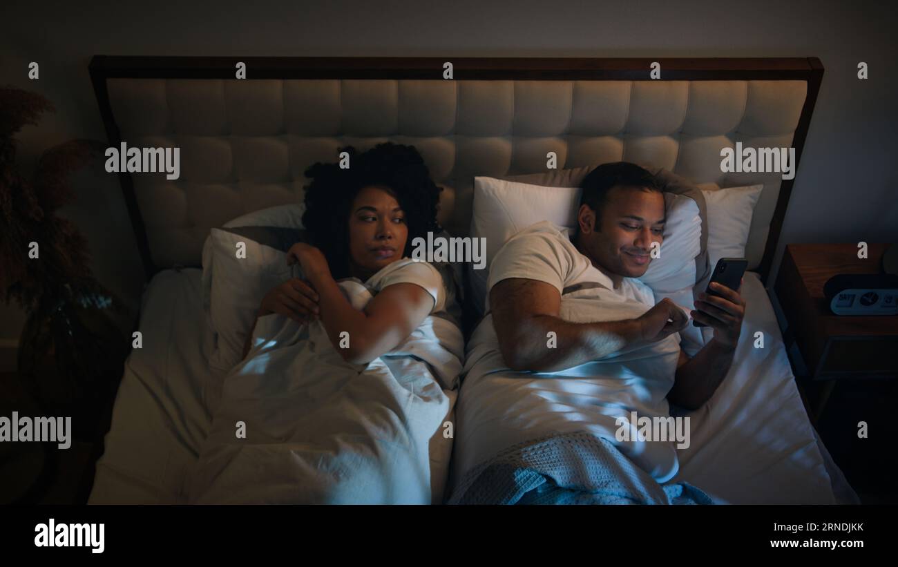 African American couple family in bed bedroom at night angry frustrated ...