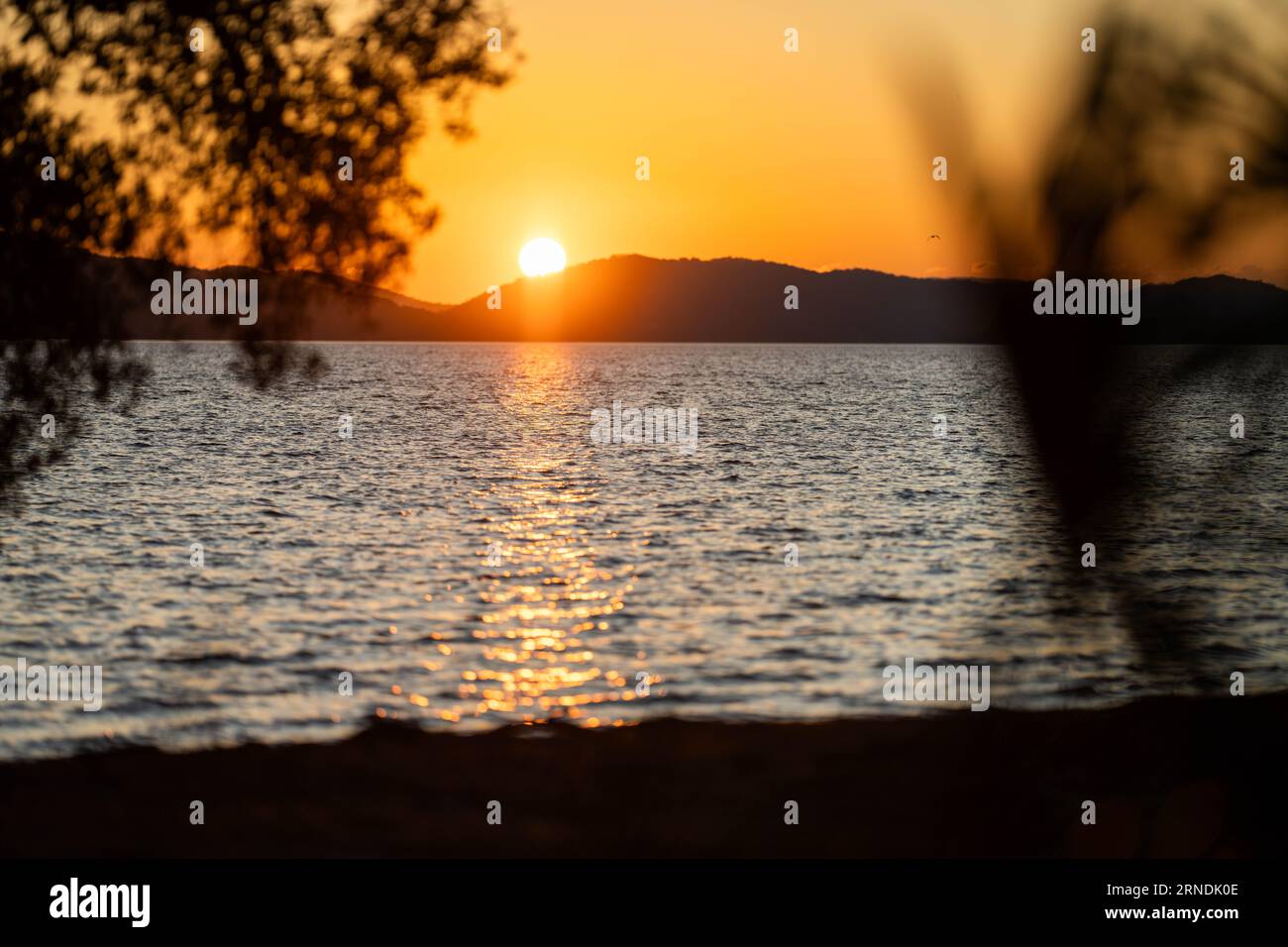 red sunset over mountains and a lake in australia reflecting Stock ...