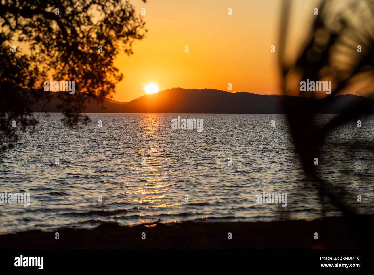 red sunset over mountains and a lake in australia reflecting Stock ...