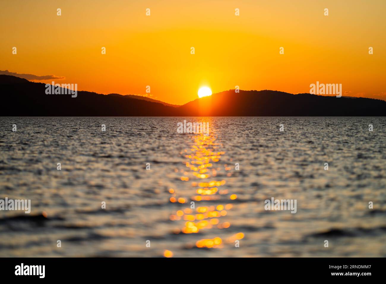 red sunset over mountains and a lake in australia reflecting Stock ...