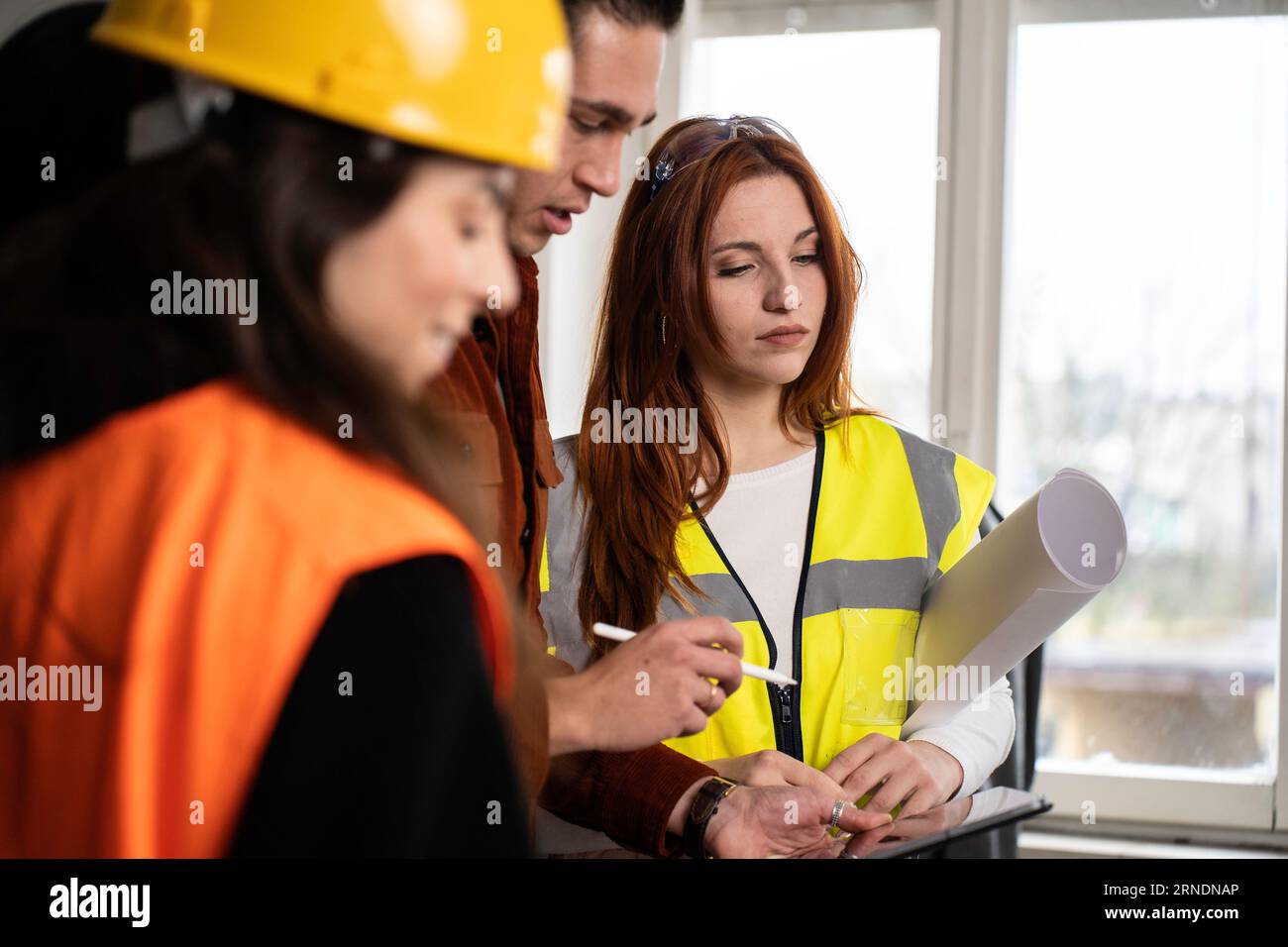Engineer supervisor at construction site with his female work team ...