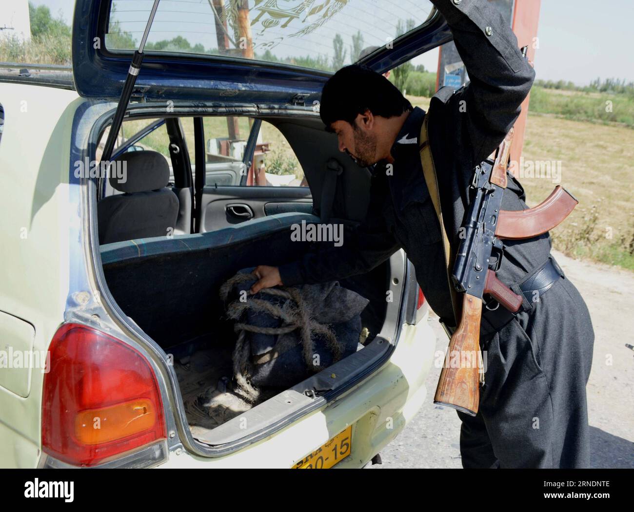 KUNDUZ, May 25, 2016 -- An Afghan policeman searches a vehicle at a ...