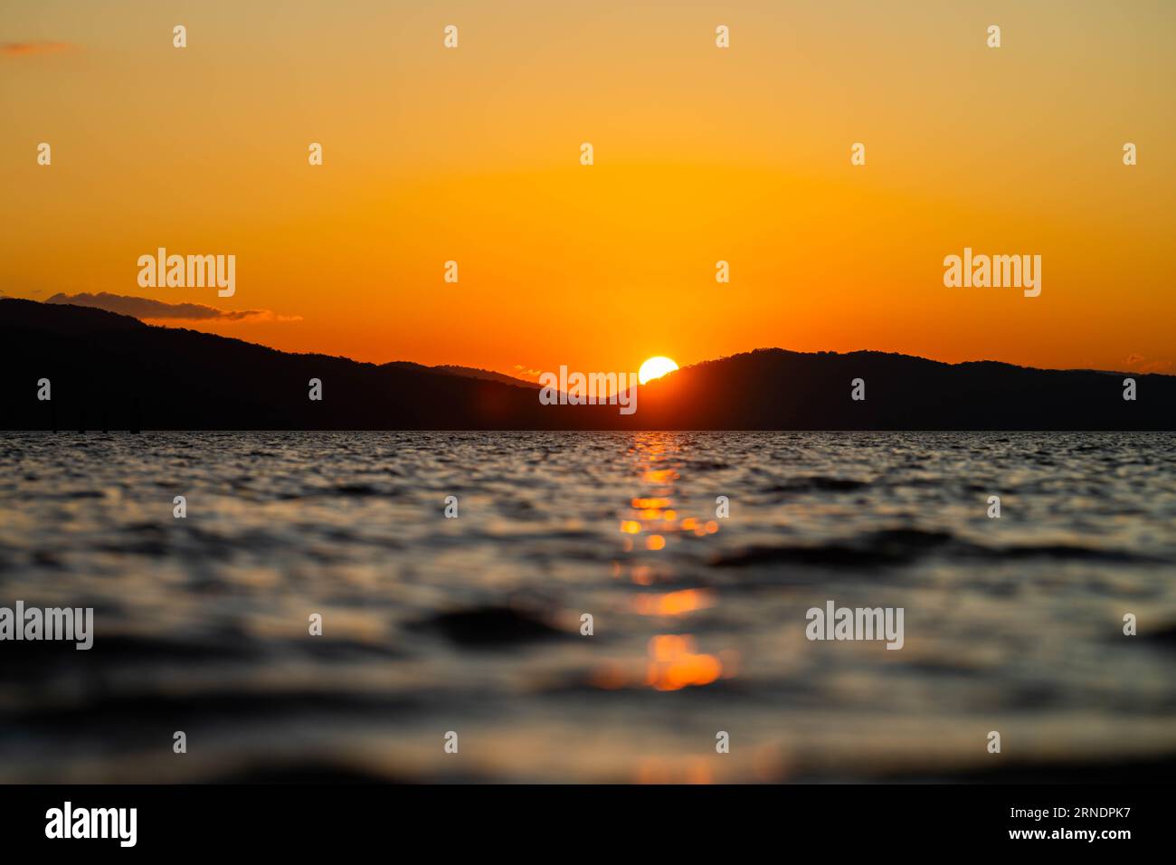 red sunset over mountains and a lake in australia reflecting Stock ...