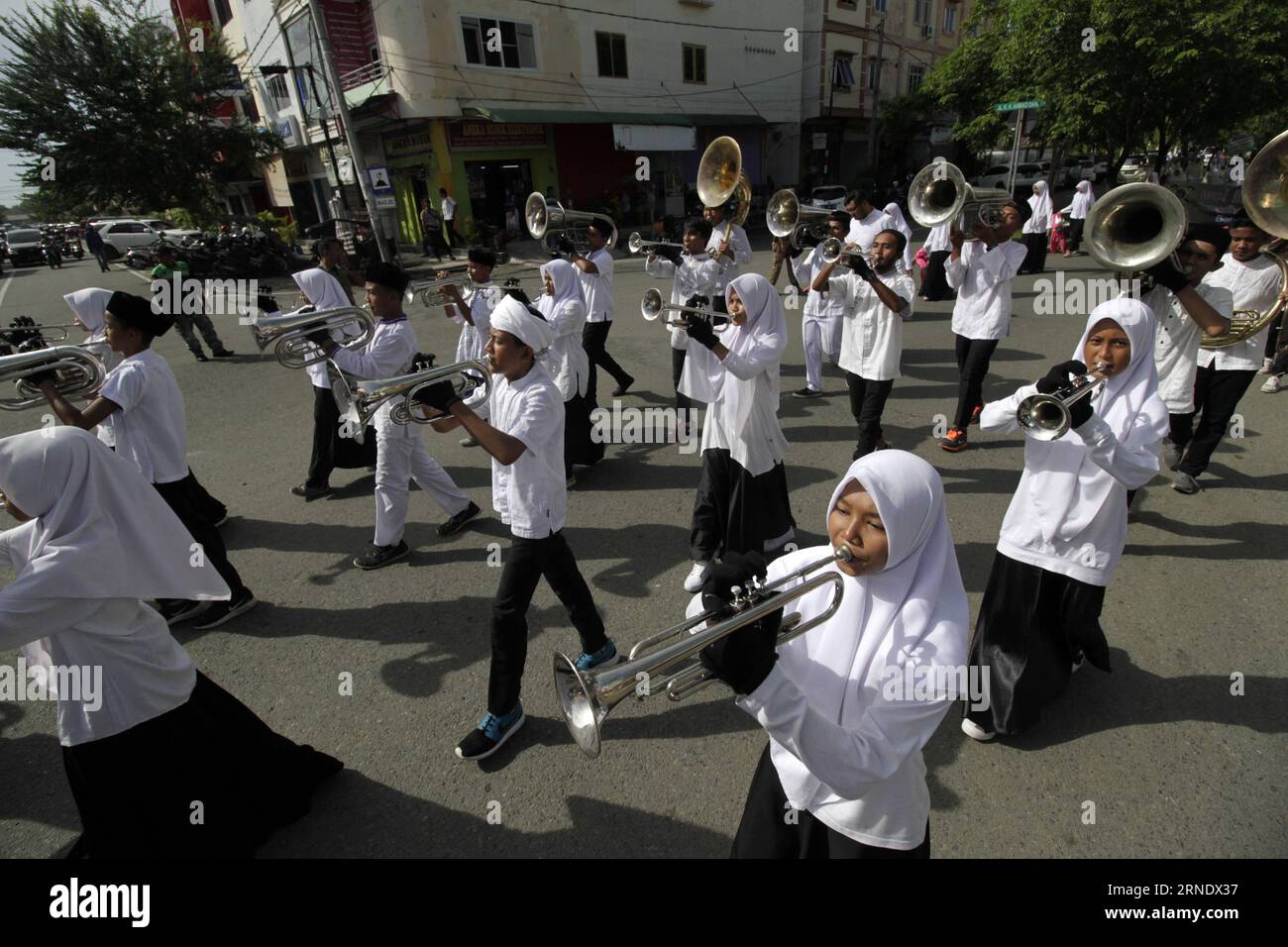 Students participate in a parade to welcome the upcoming Ramadan in ...