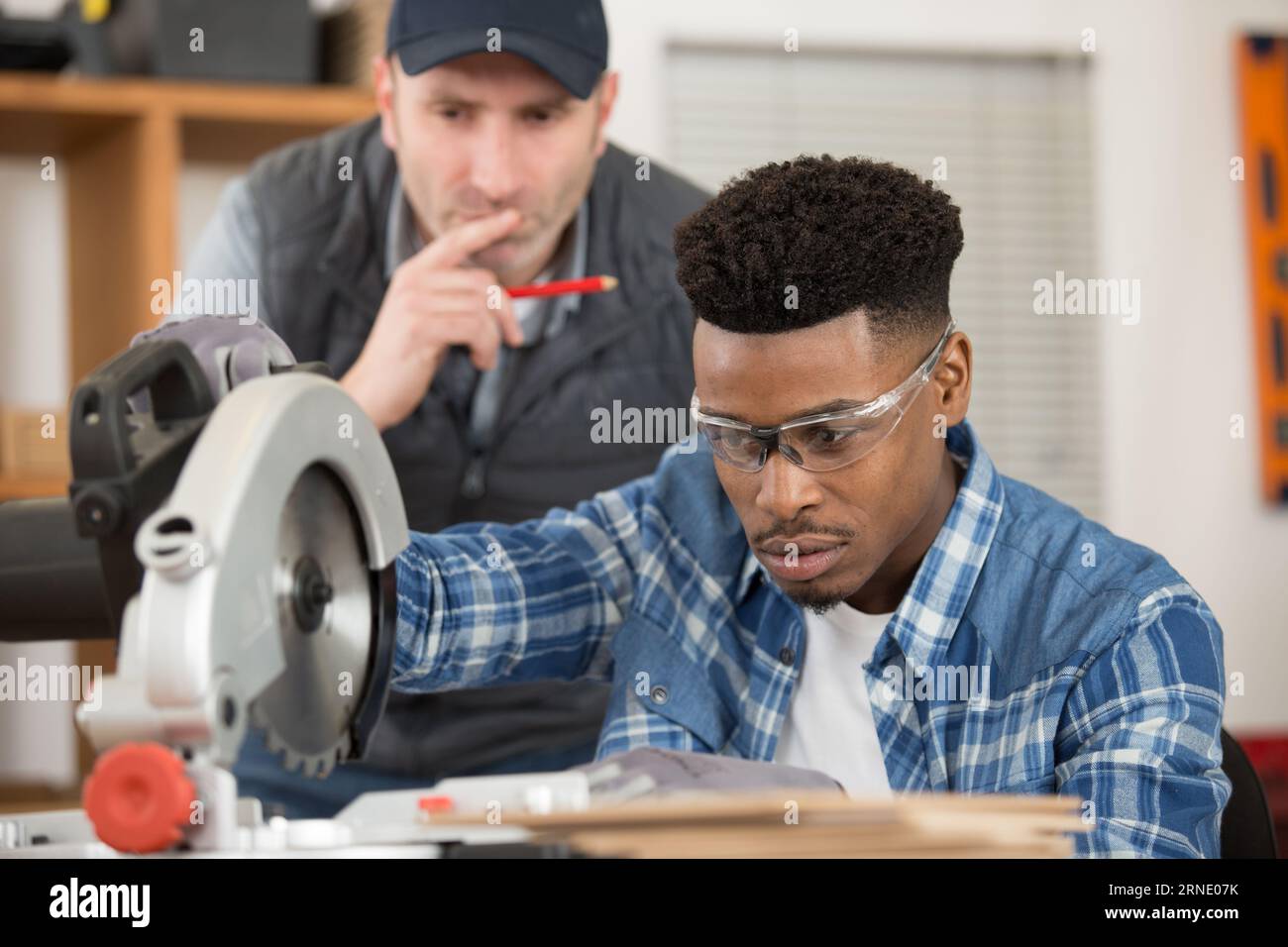 young apprentice learning to use circular saw Stock Photo - Alamy