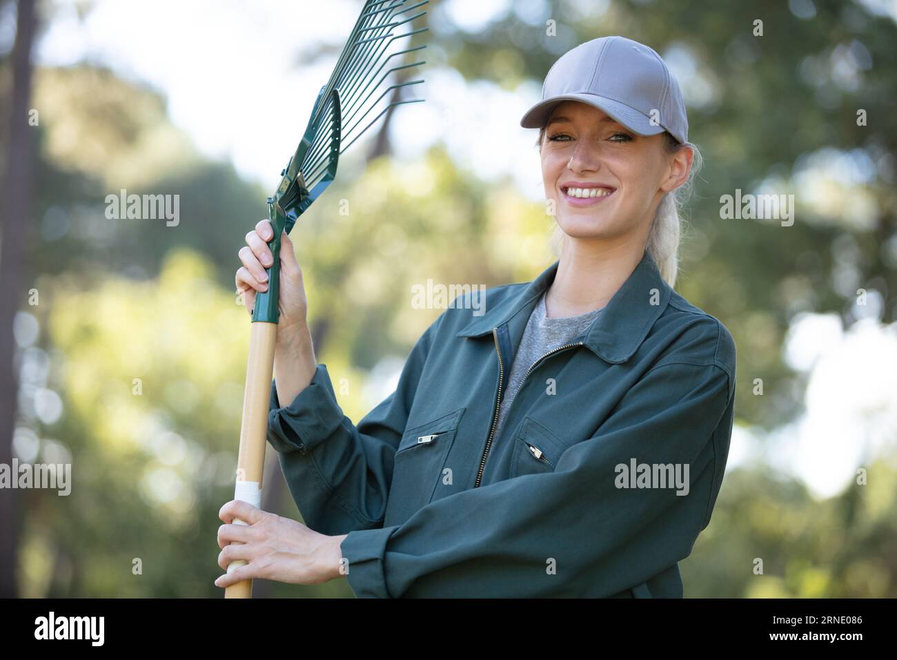 Happy female farmer holding shovel hi-res stock photography and images ...