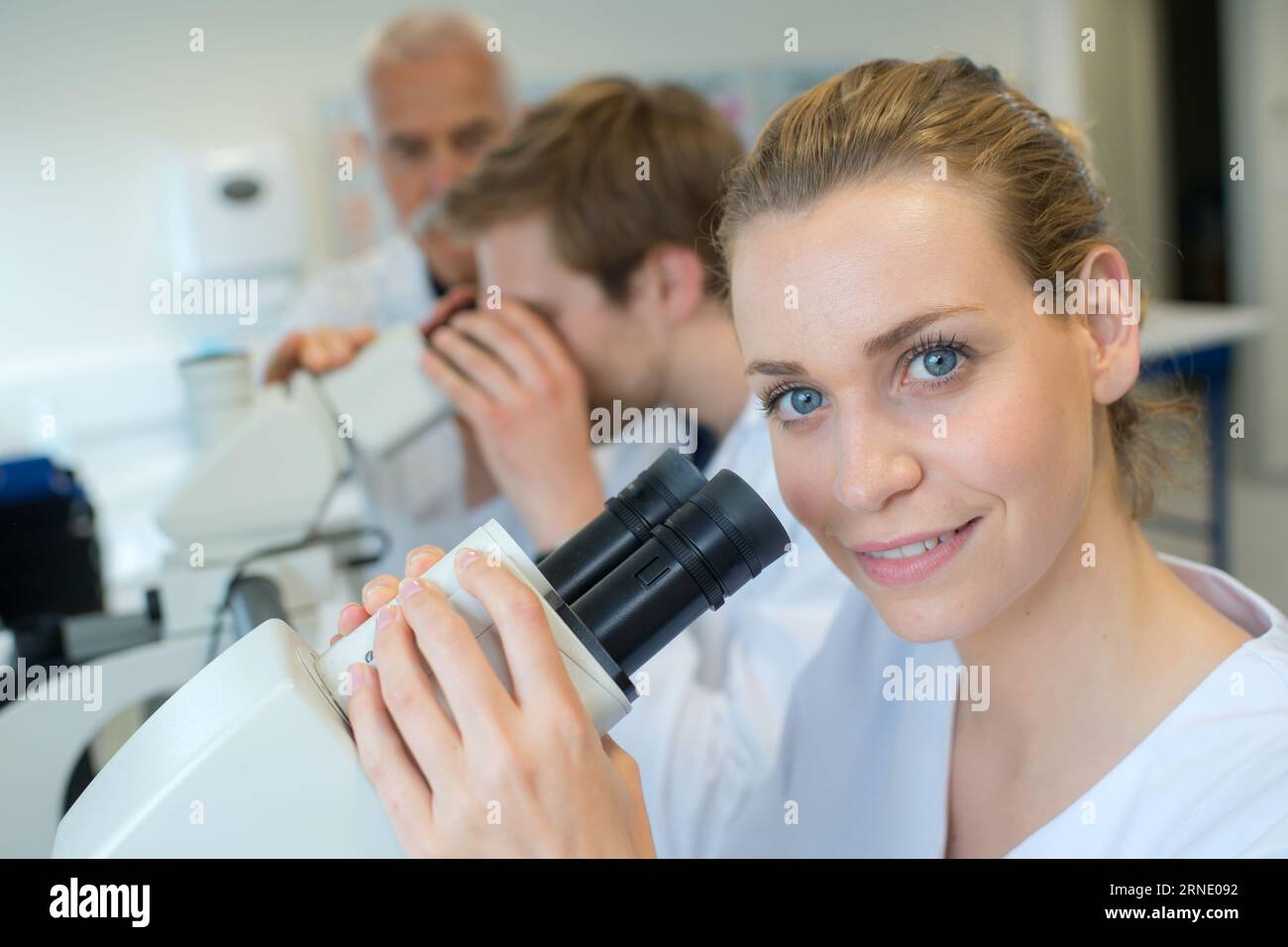 beautiful female medical doctor using a microscope Stock Photo - Alamy
