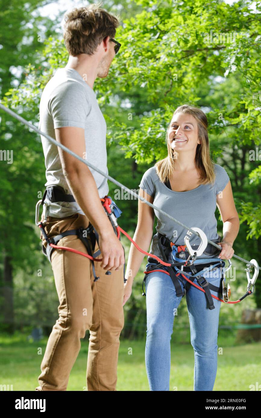 boyfriend and girlfriend couple standing in a rope park Stock Photo - Alamy