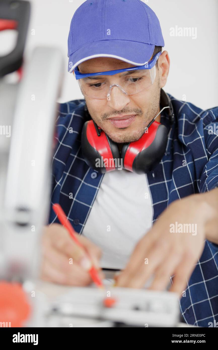 close view of workman marking position with pencil Stock Photo - Alamy
