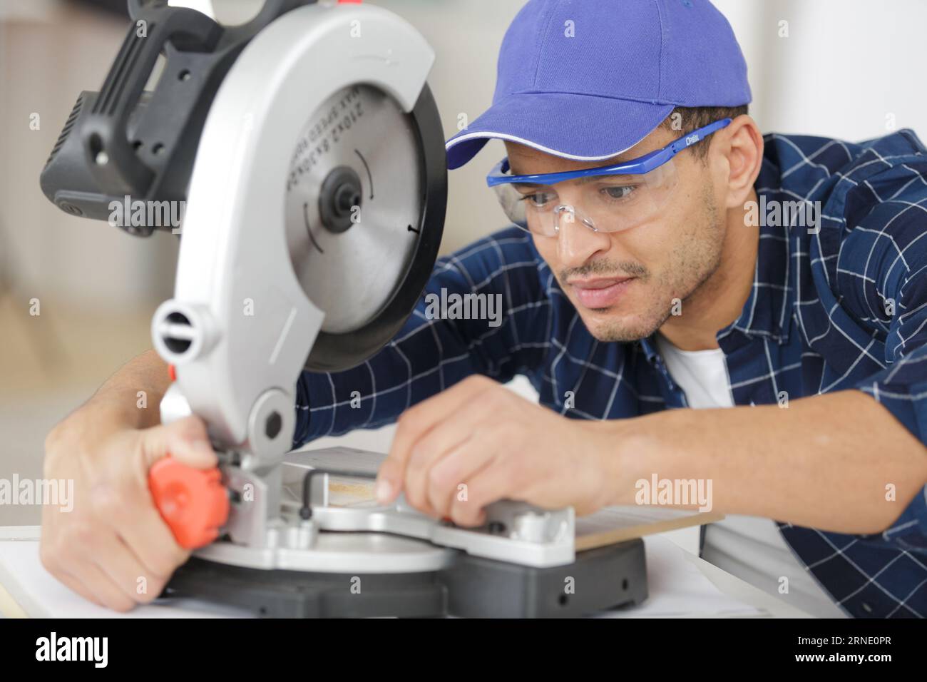 hard working carpenter cutting wooden plank Stock Photo - Alamy