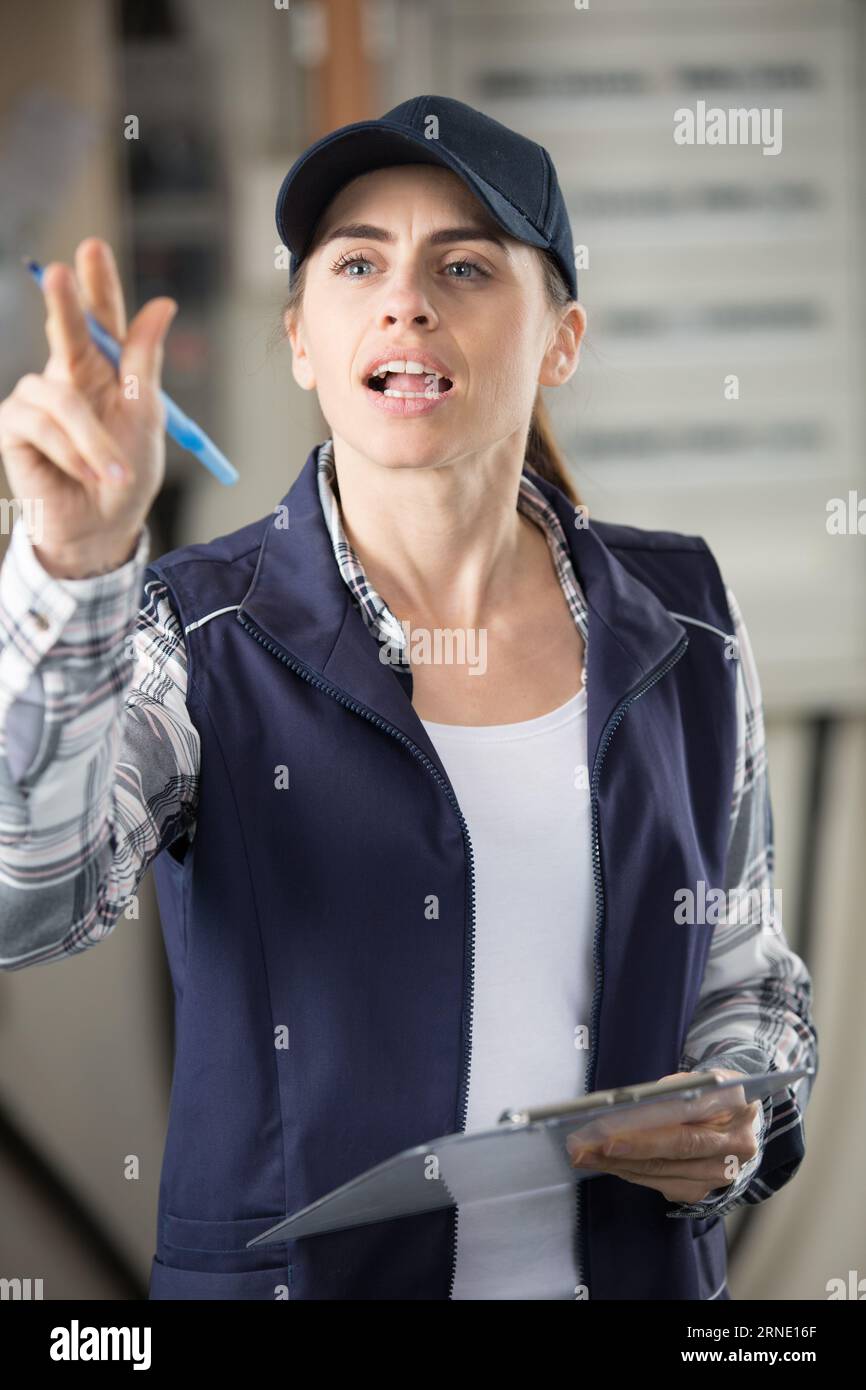 worker with clipboard calling a worker Stock Photo - Alamy